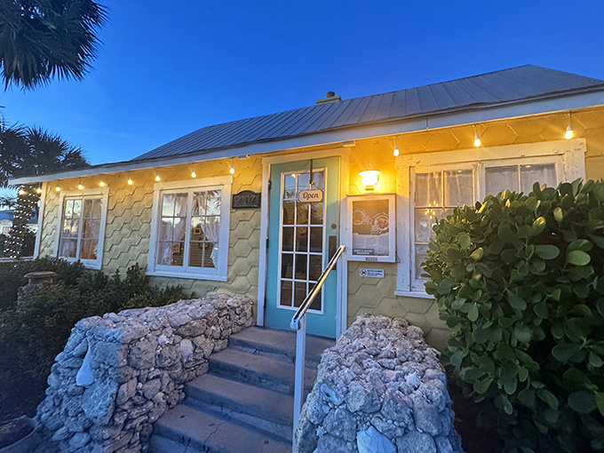 The Porch Restaurant glows with island charm at dusk &ndash; its honeycomb-yellow exterior as warm and inviting as the meals served inside.