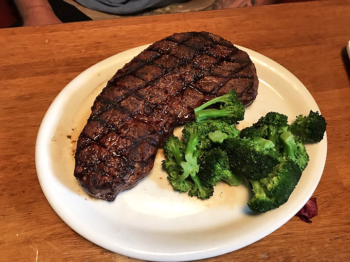 The Sheriff steak commands the plate with authority, its perfect grill marks evidence of a kitchen that knows exactly what it's doing.