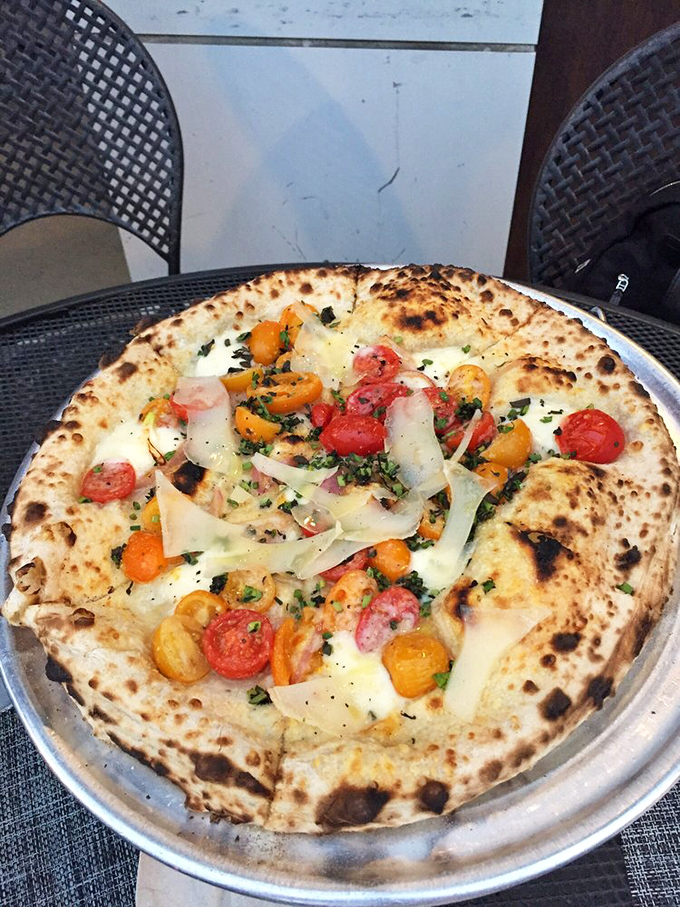 Heirloom tomatoes and fresh cheese on a canvas of perfect dough. Like a summer garden party where everyone actually gets along.