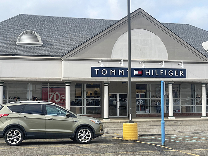 Tommy Hilfiger's storefront proudly displays discounts that would make even the most frugal shopper's heart skip a beat.