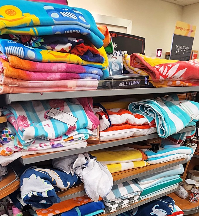 Beach towels and bedding in technicolor glory. Someone's summer memories folded neatly, ready for your next poolside adventure or bedroom makeover.