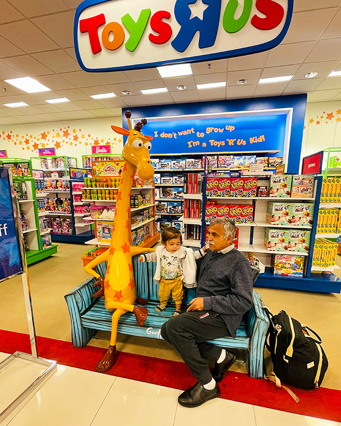 The iconic giraffe bench at Toys"R"Us creates multi-generational moments&mdash;where grandparents rest while imaginations run wild through aisles of possibility.