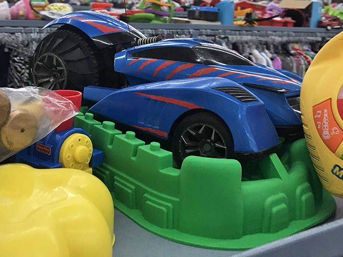 Childhood joy in plastic form. That race car probably outran a toddler's attention span before landing here, ready for its second lap.