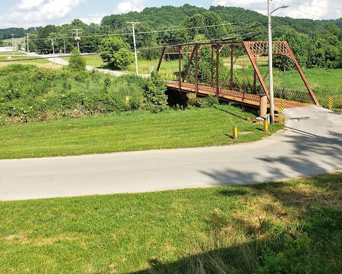 This rustic truss bridge spans a peaceful Indiana creek, a testament to the practical engineering that made rail travel possible through challenging terrain.