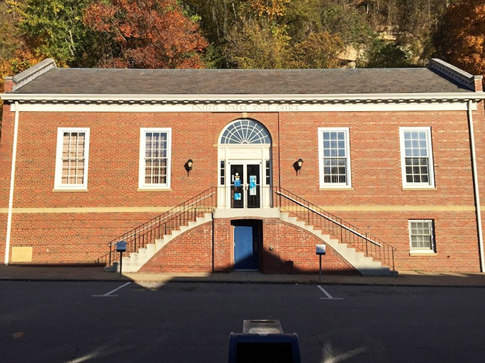 The brick post office stands as solid as the community it serves, where mail delivery isn't just a service but a daily social connection.