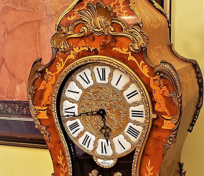 This ornate clock doesn't just tell time&mdash;it tells stories. With its intricate woodwork and regal face, it's practically royalty in furniture form.
