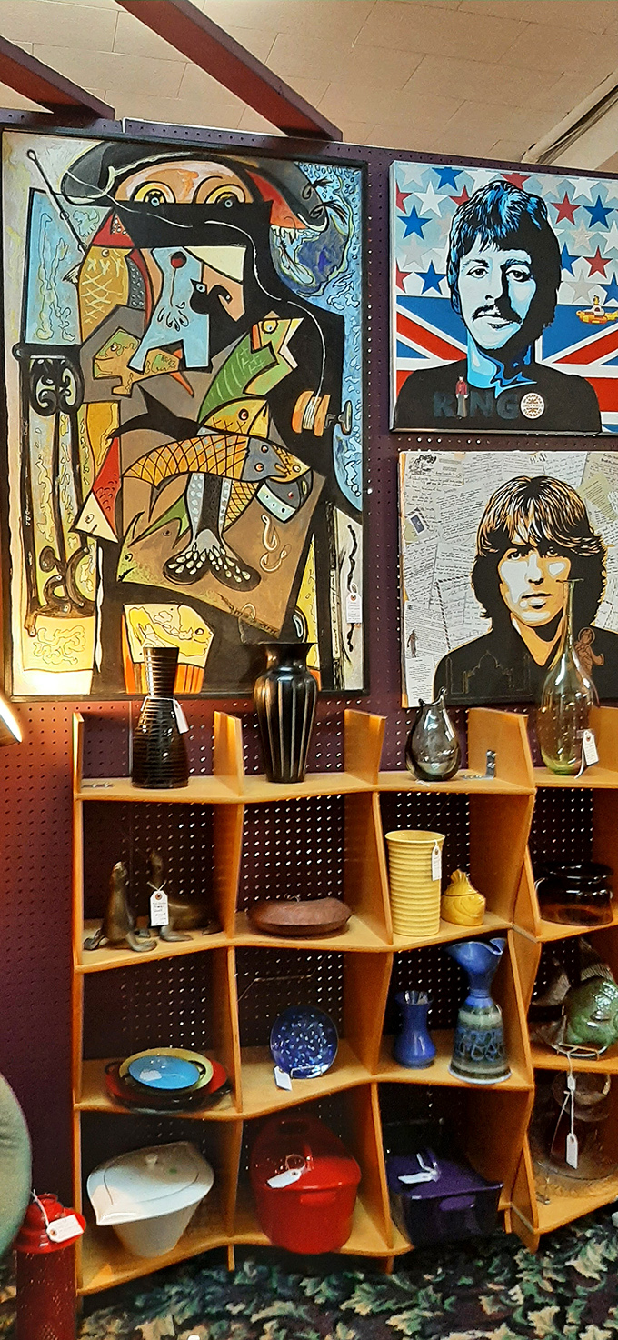 The Beatles watching over mid-century treasures. This display combines pop culture icons with functional art for the ultimate nostalgic corner.