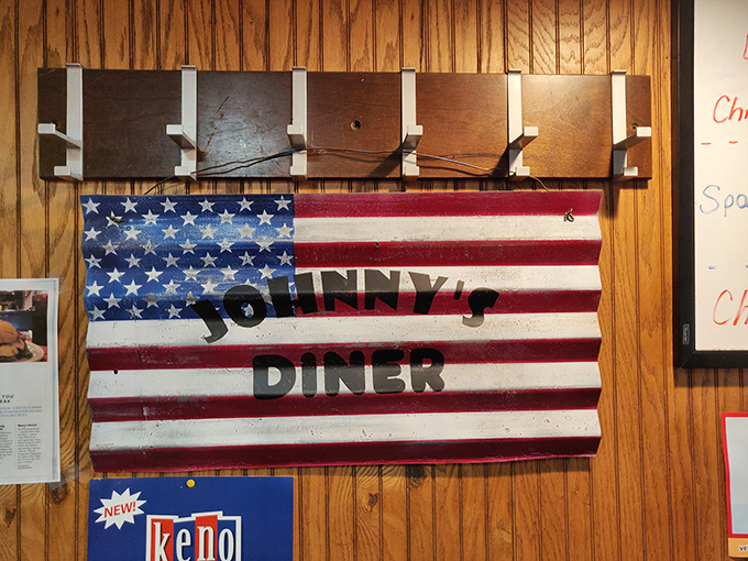 The American flag proudly displays the diner's name – because nothing says "authentic American experience" quite like eggs and bacon in a no-frills joint.