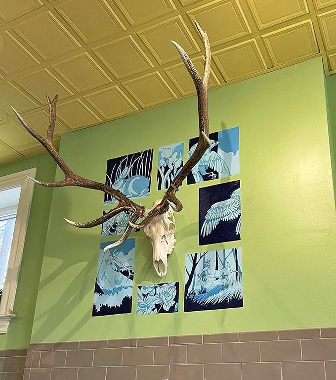Eclectic wall décor featuring antlers and bird-themed art creates a space that's both rustic and refined—like Missouri itself.