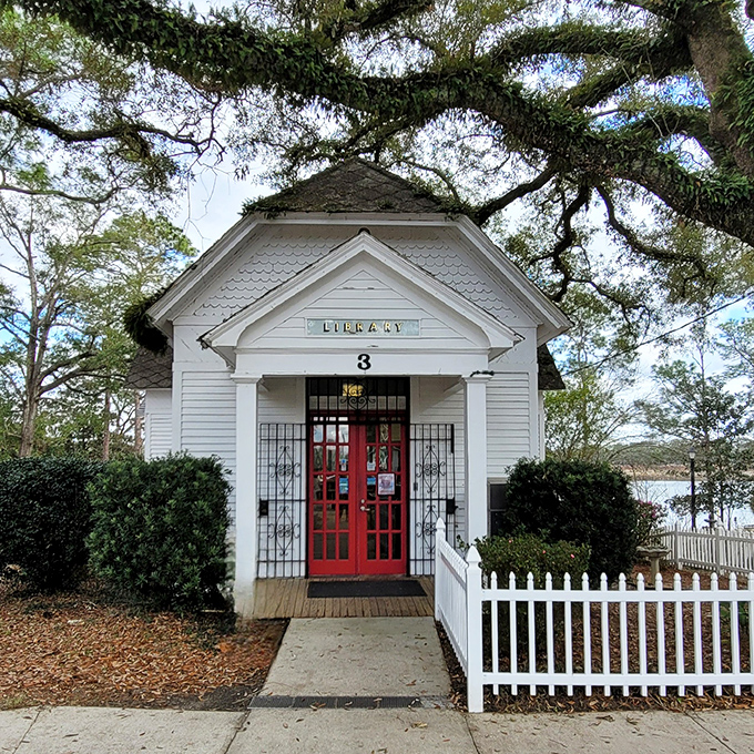 The Walton-DeFuniak Library's quaint white cottage and red door invite you into a world where books still smell like adventure.