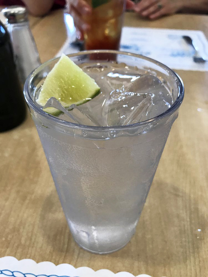 A glass of water with lime that's just killing time until you order something more interesting, like everything else on the menu.