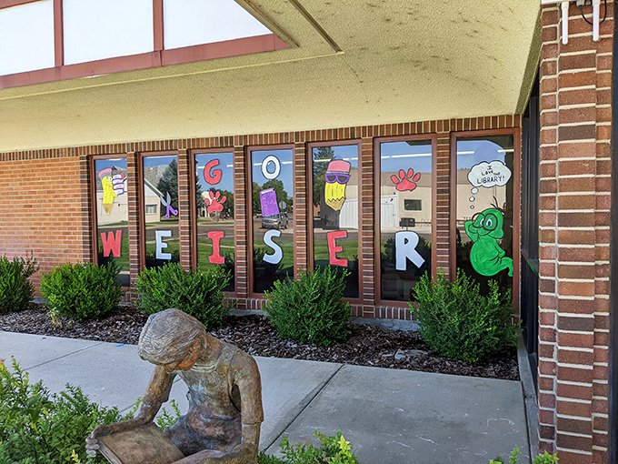 Weiser's colorful library windows welcome readers of all ages, with a sculpture that perfectly captures how we all feel after finishing a good book.