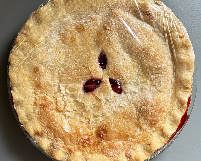 This golden-topped cherry pie isn't trying to win a beauty contest – it's aiming straight for your childhood memories and hitting the bullseye.