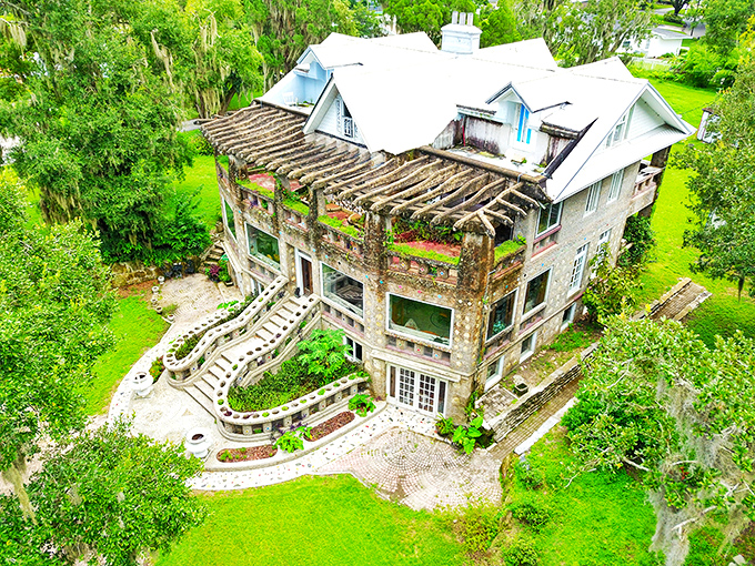 From this perspective, Wonder House emerges from its verdant setting like a concrete castle holding court among the palms.