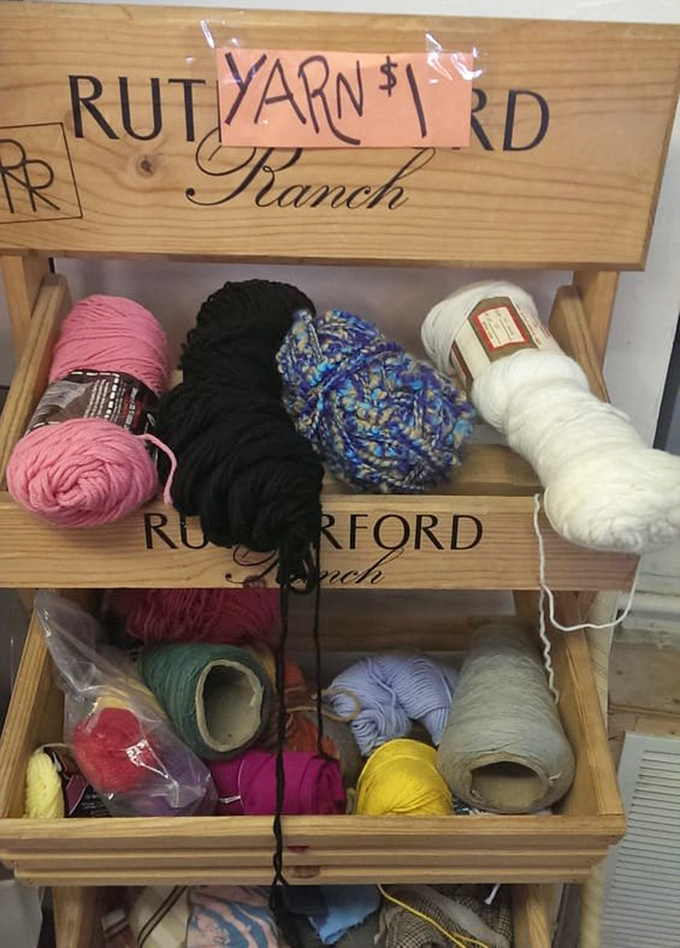 Crafters take note: this repurposed wine rack now cradles colorful yarn skeins, each holding potential for someone's next handmade masterpiece.