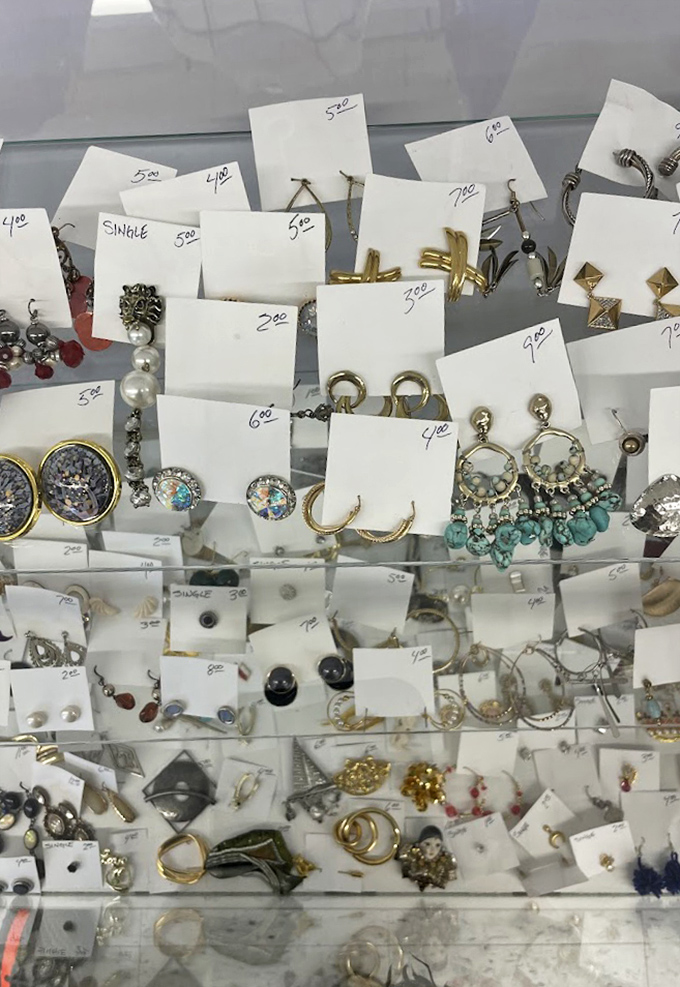 Jewelry display case: tiny treasures on white cards, like a deconstructed pirate's chest where X marks every bargain.