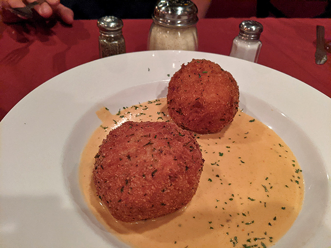 Arancini: Italy's answer to "Can we make rice even better?" Crispy outside, creamy inside, and swimming in sauce that demands bread for dipping.