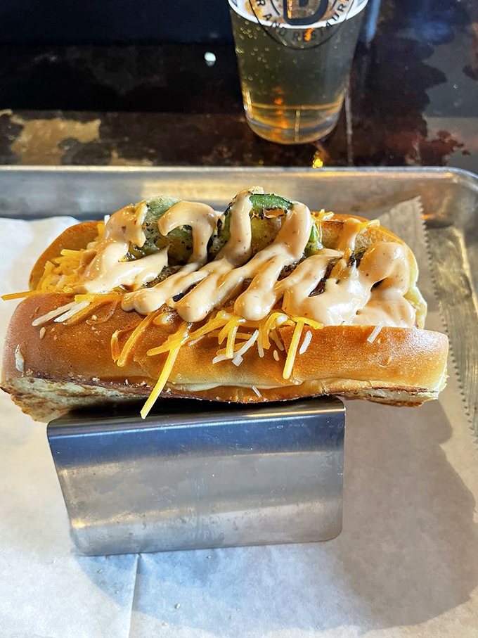A hot dog that went to art school. Shredded cheese, special sauce, and what appears to be jalape&ntilde;os create a masterpiece that's almost too pretty to eat. Almost.