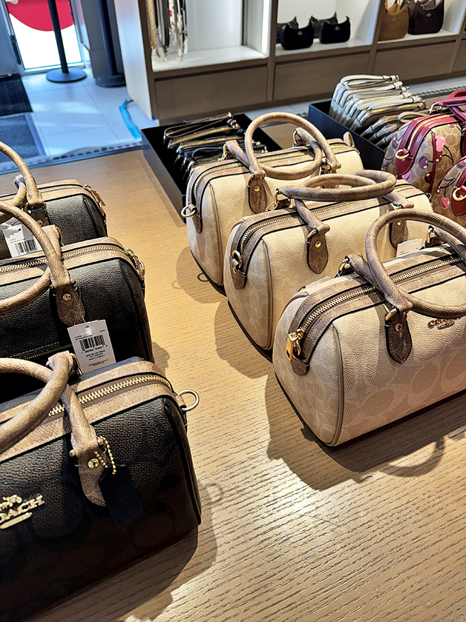 These Coach bags aren't just accessories &ndash; they're tiny leather dreams arranged in neat rows, whispering promises of organization and style.