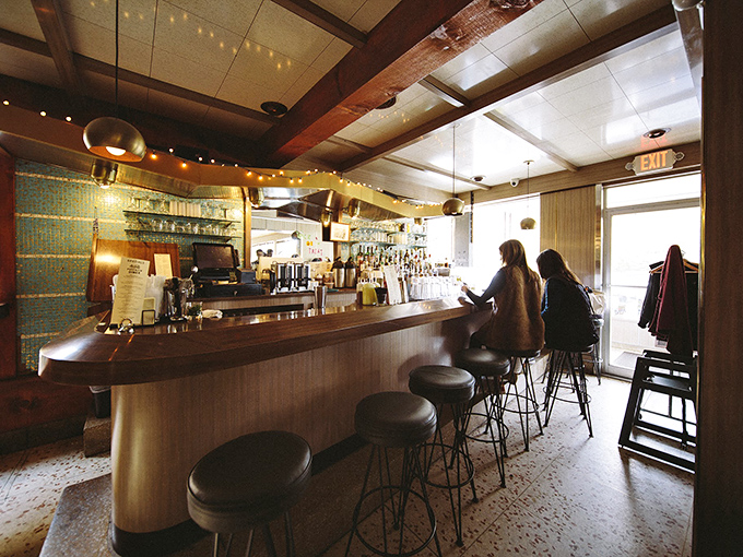 A bar that transforms from morning coffee station to evening cocktail haven, where stools invite you to stay just a little longer.