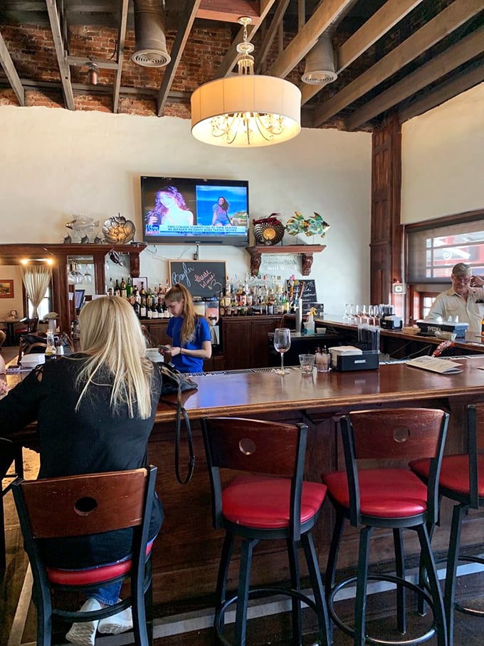 The bar's exposed brick and warm wood create that perfect sweet spot between rustic charm and polished comfort &ndash; like your favorite jeans but in restaurant form.