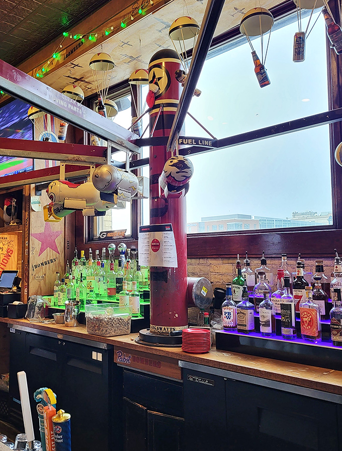 The bar at AJ Bombers isn't just serving drinks&mdash;it's serving atmosphere, with parachuting bottles and aviation-themed decor that makes ordering a beer feel like an adventure.