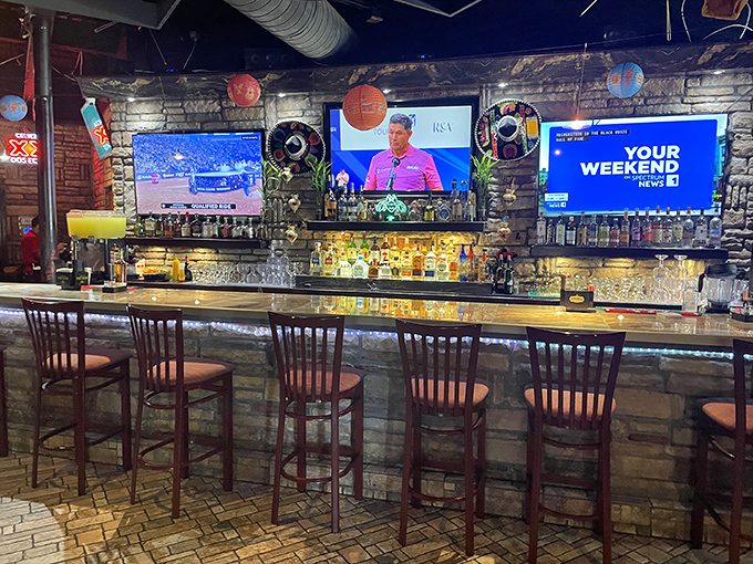 The bar's stone facade isn't just decorative&mdash;it's holding back a tequila tsunami. Those TVs ensure you won't miss the game while sipping.