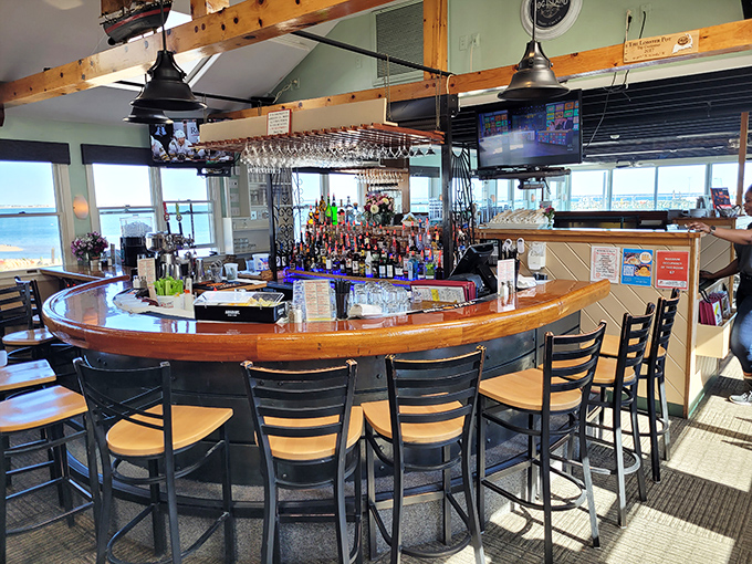 The curved bar offers front-row seats to both mixology magic and that million-dollar harbor view. Cocktail with a view? Yes, please.