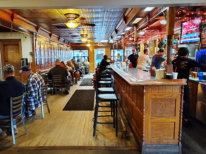 The bar area offers a front-row seat to the action, where regulars gather like disciples at the altar of exceptional barbecue.