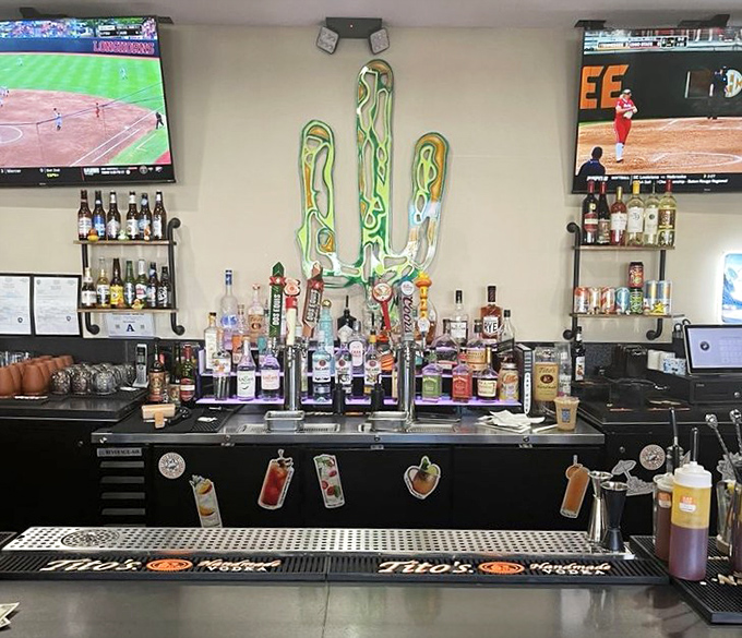 The bar's neon cactus glows like a southwestern beacon, promising libations that pair perfectly with comfort food classics.