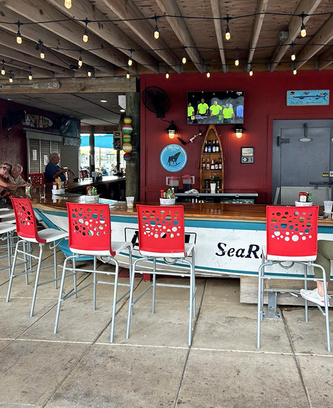 The outdoor bar area where boat-shaped seating makes every meal feel like a nautical adventure without seasickness.