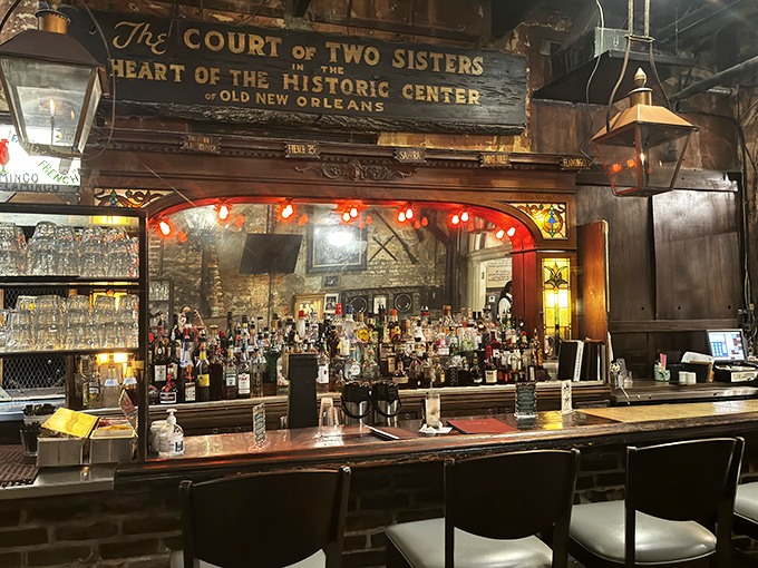 The bar at Court of Two Sisters doesn't just serve drinks&mdash;it serves history with a twist, under the warm glow of vintage lighting.