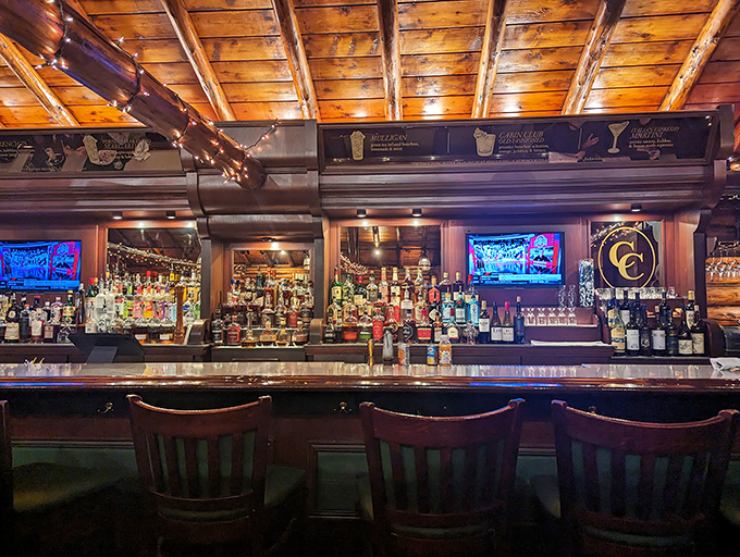 The bar showcases enough premium spirits to make prohibition supporters weep, all displayed beneath the warm glow of wooden rafters.