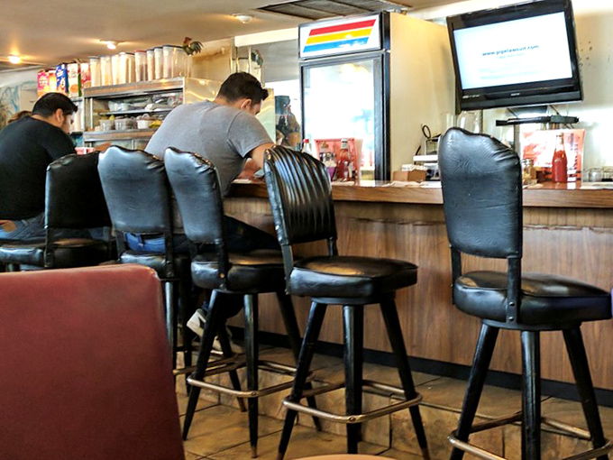 Counter seating &ndash; where solo diners become temporary members of the breakfast club and coffee refills arrive before you realize you need one.