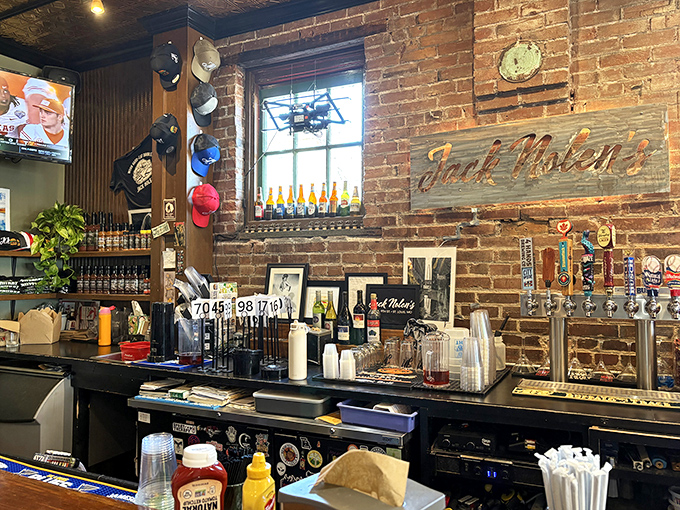 The rustic bar area with its wooden sign and tap handles promises liquid refreshment to complement your burger journey.