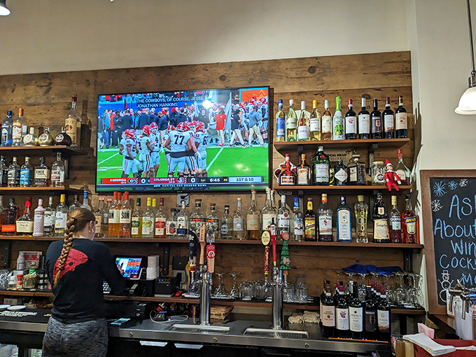A bar stocked for serious enjoyment, where sports on TV and spirits on shelves create the perfect pizza pairing station.