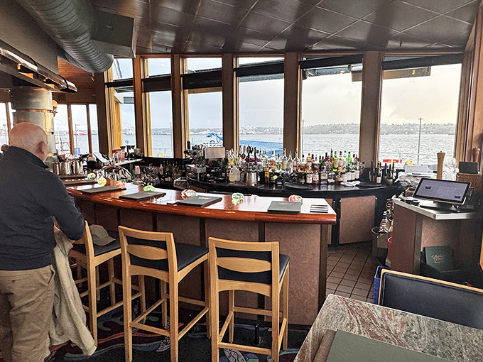 The bar overlooks the water, offering front-row seats to Elliott Bay's endless maritime entertainment.