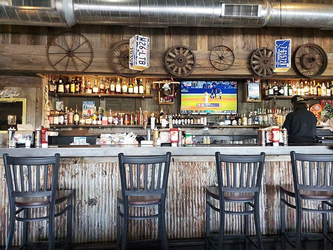 License plates and wagon wheels tell stories on the walls, while the bar stools below await the next chapter of your barbecue adventure.