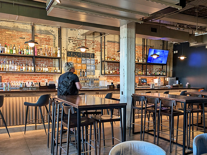 A bar backed by exposed brick that practically whispers, "Stay awhile, your Old Fashioned is about to change your life."