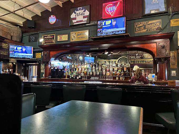 The bar area showcases vintage beer signs and a magnificent wooden bar that's witnessed decades of toasts, tales, and occasional tall stories.