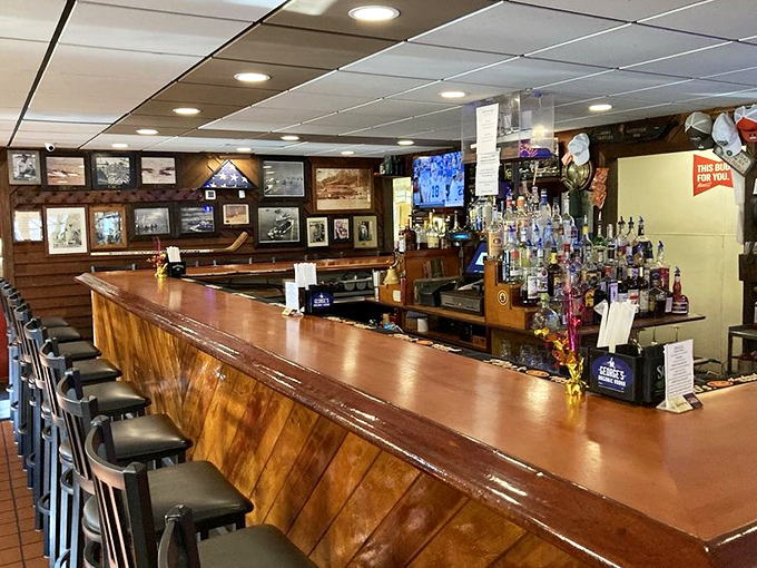 The polished wood bar at Cantler's has heard more fishing stories than a tackle shop. Each bottle behind it promises liquid courage for first-time crab pickers.