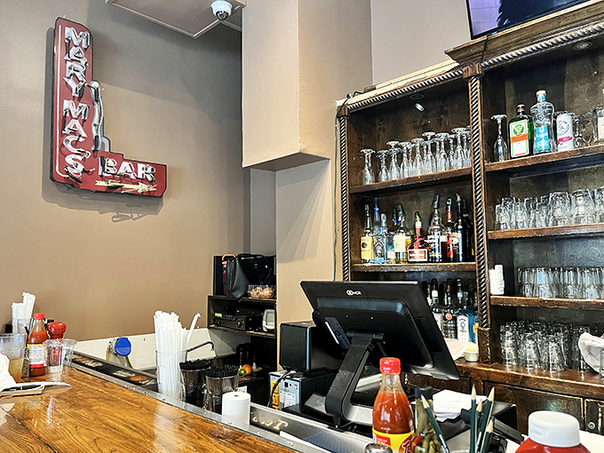 The bar area's vintage sign and wooden shelving speak to decades of toasts and celebrations, a liquid complement to the comfort food empire.