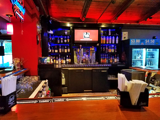 The bar area glows with promise—because nothing complements seafood quite like a cold beverage and neon ambiance.