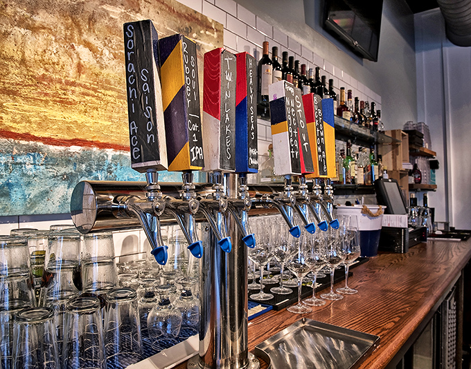 The bar's colorful tap handles stand ready like soldiers, each representing a different craft brew adventure. Decisions, decisions.