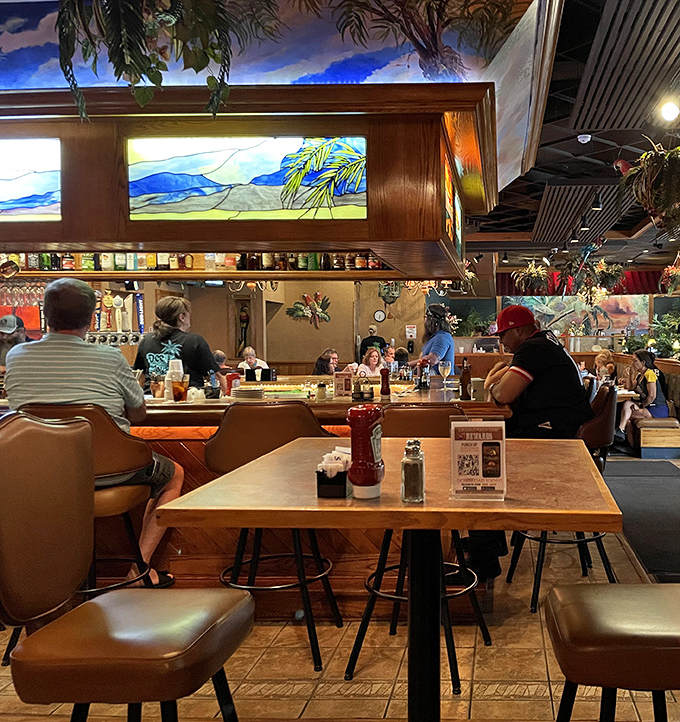 The bar area glows with stained glass warmth. Those hanging lamps cast the kind of light that makes everyone look like they're on vacation&mdash;even on a Tuesday.