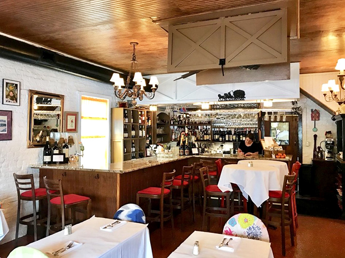 The bar area combines old-world charm with enough bottles to make any mixologist feel right at home.