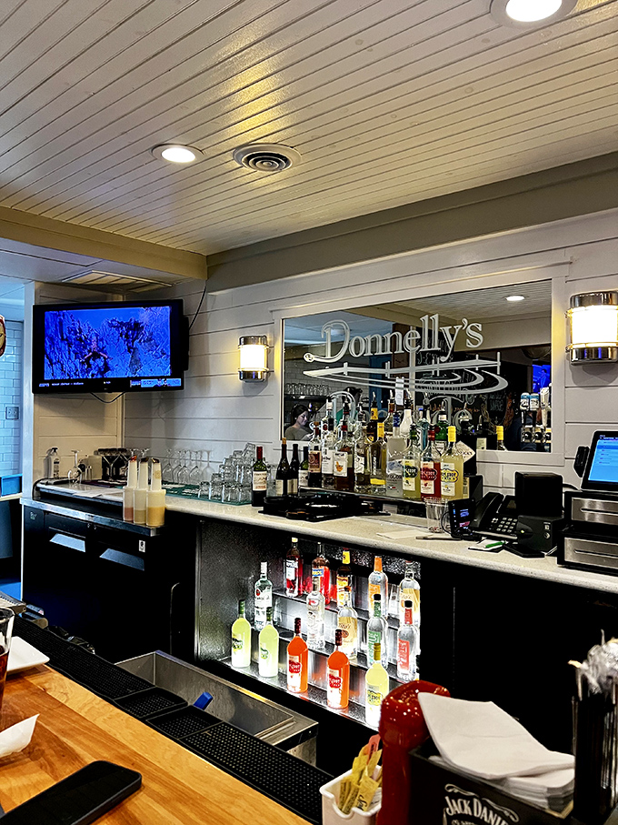 The bar area gleams with promise &ndash; cold drinks, good company, and that Donnelly's sign reflecting in the mirror.