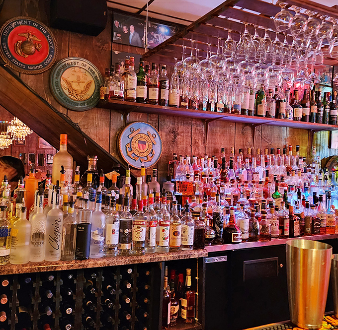 A bar stocked better than most liquor stores. Those military emblems on the wall remind you this place has serious history and respect.