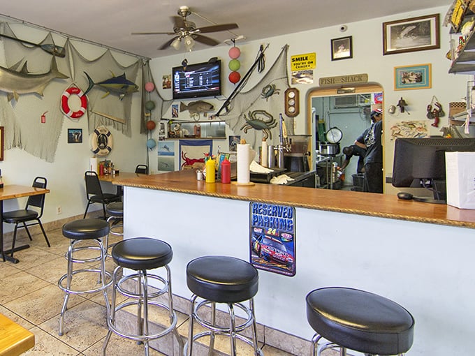 The counter where seafood dreams come true. Those fishing nets and nautical decorations weren't bought from a catalog—they've earned their place on these walls.