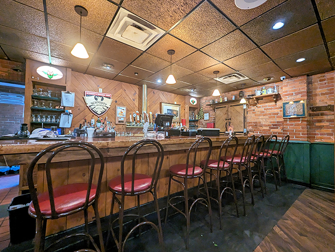 The bar isn't trying to be trendy; it's aiming for timeless. Those red-cushioned stools have heard every story this town has to tell.